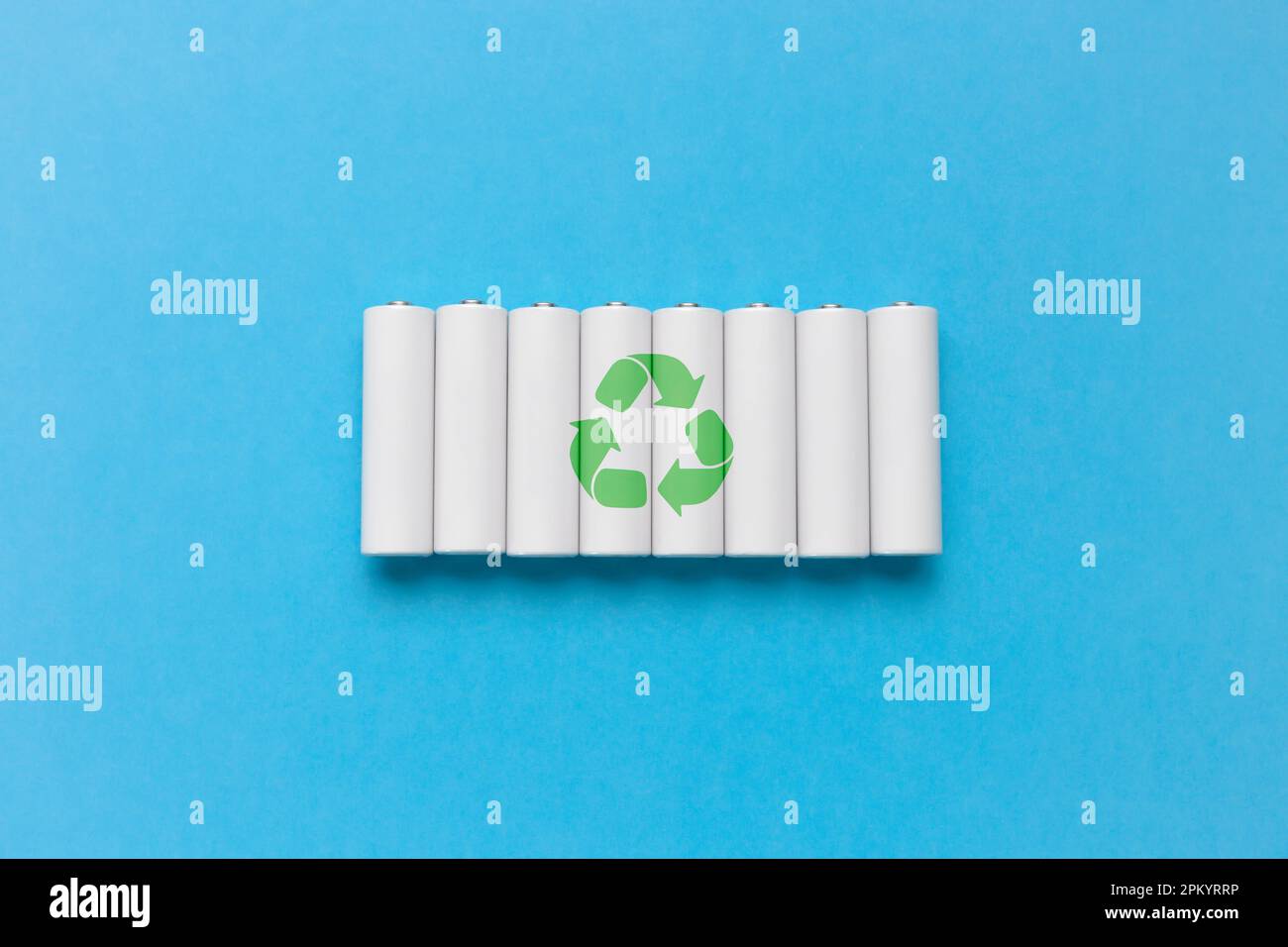 Overhead view of set of white colored batteries in row representing ...