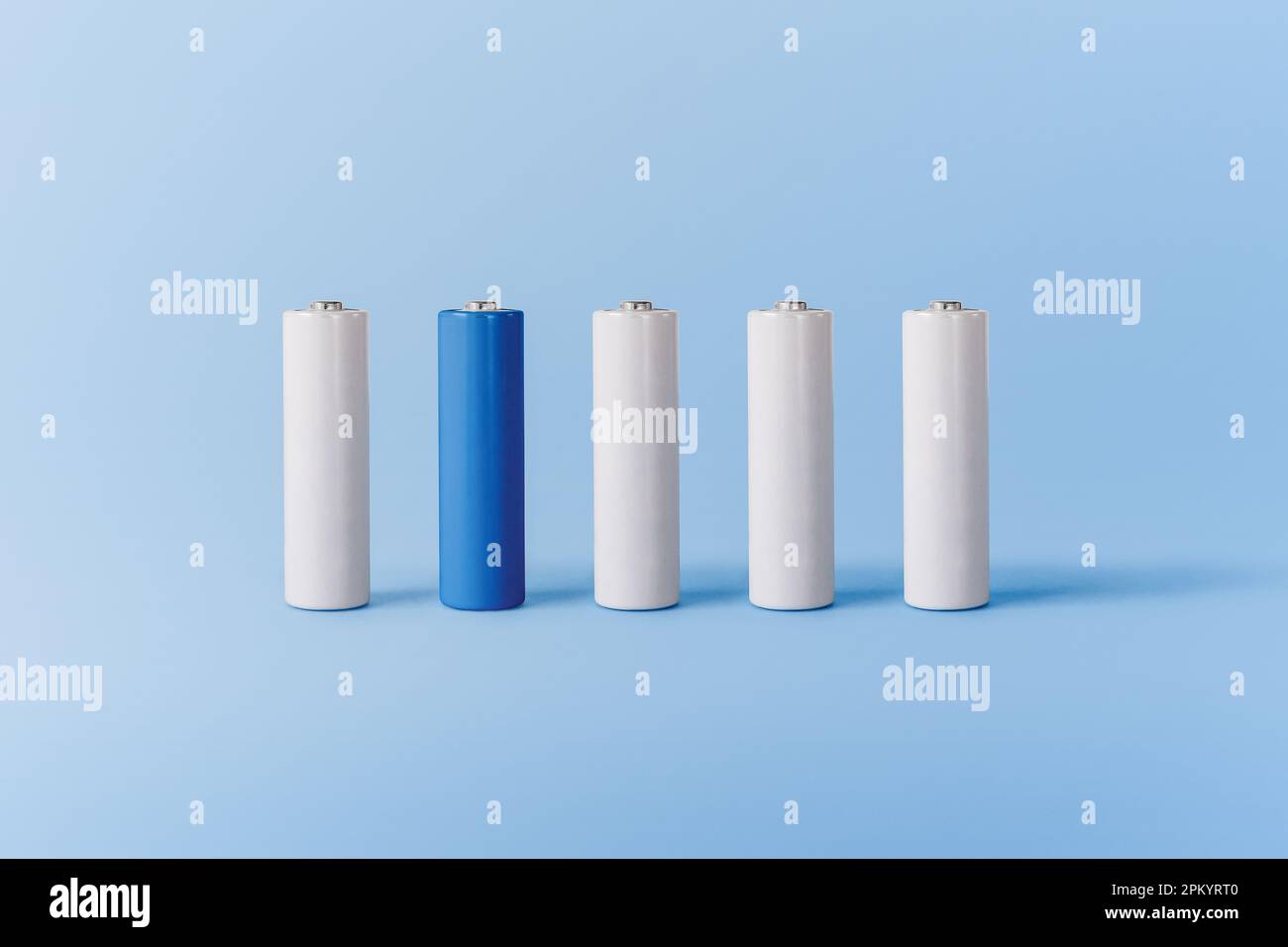 Set of various white and blue colored batteries placed on blue surface ...