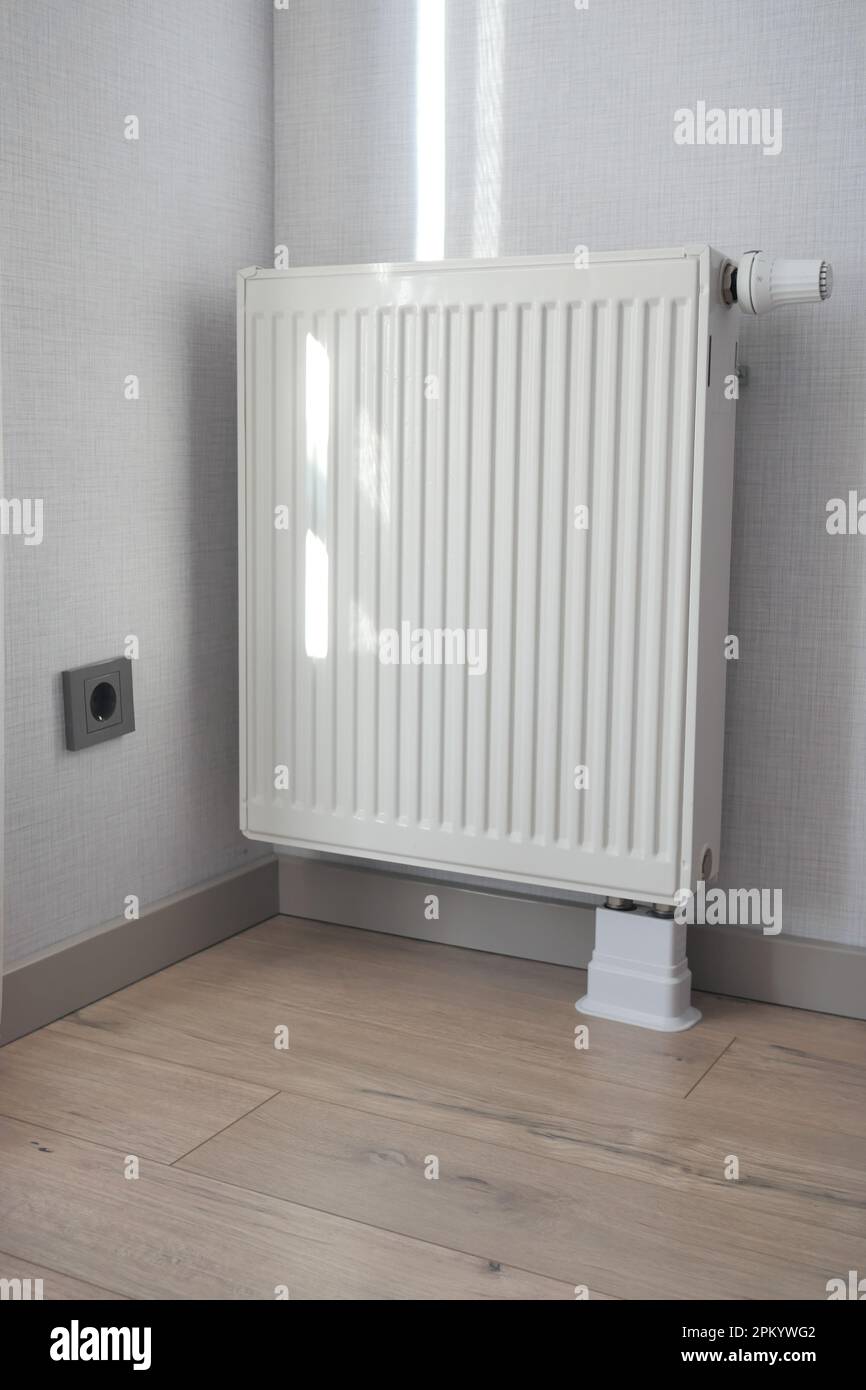 heating radiator under window in the room Stock Photo - Alamy
