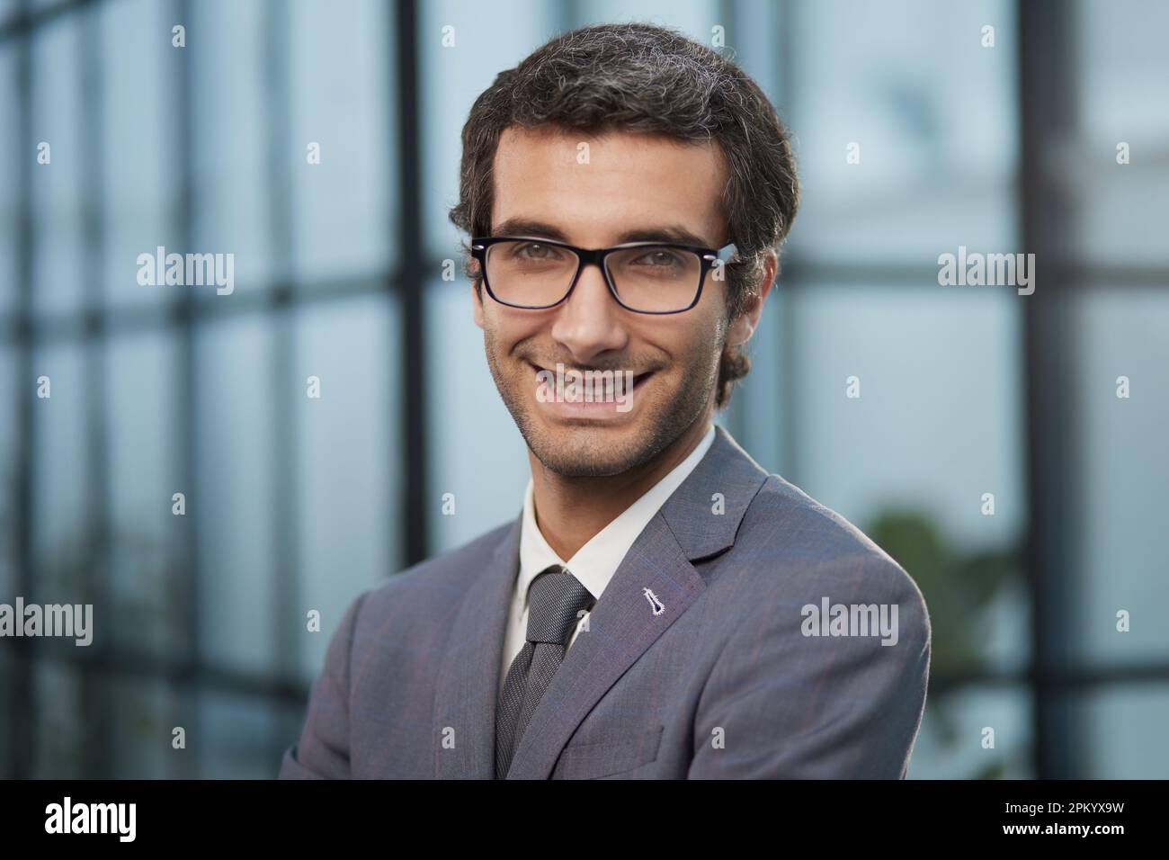 Dedicated to his business. Shot businessman standing with his arms ...