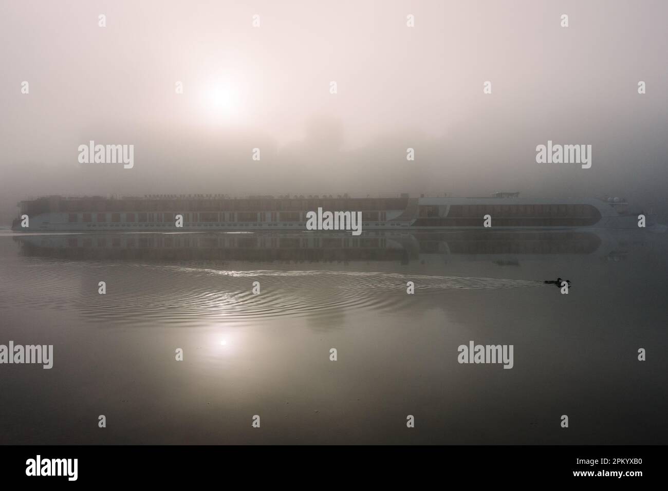 Boat sailing on water between fog Stock Photo - Alamy