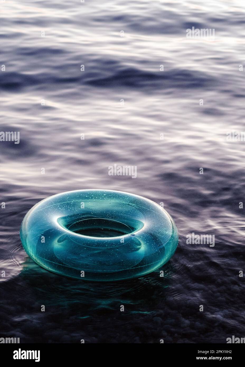 Blue transparent swimming circle floating on clear rippling sea in ...
