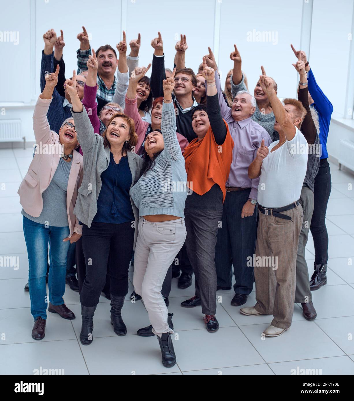 a group of older people raised their hands trying to reach Stock Photo ...