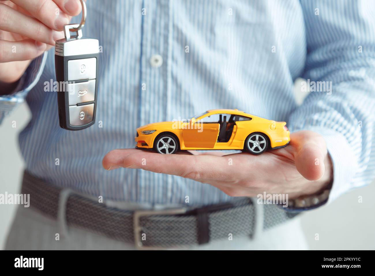 Hand holding a miniature car hi-res stock photography and images - Alamy