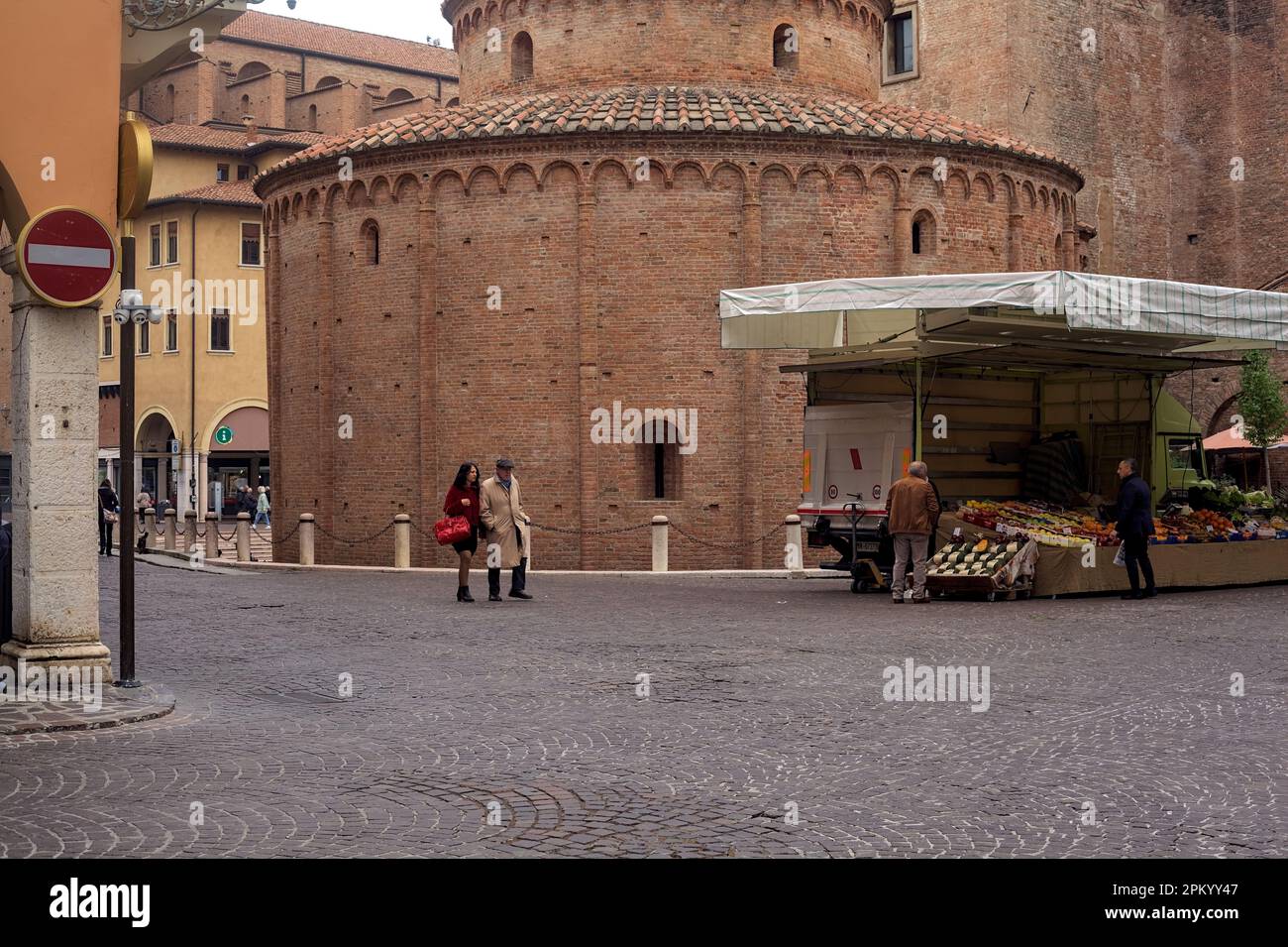 Grocery stall in a square behind historical buildings in a town on a ...