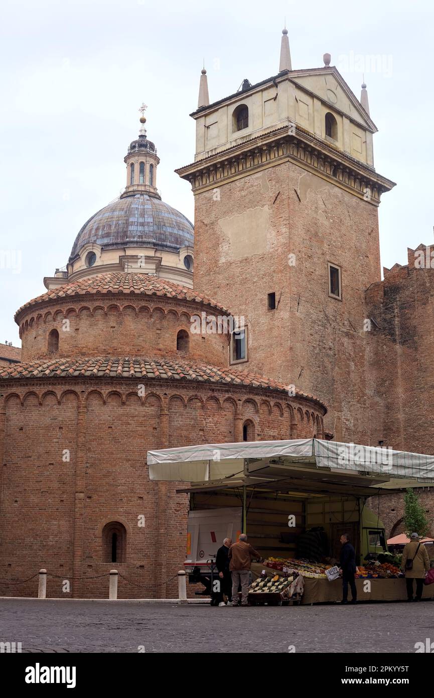 Grocery stall in a square behind historical buildings in a town on a ...
