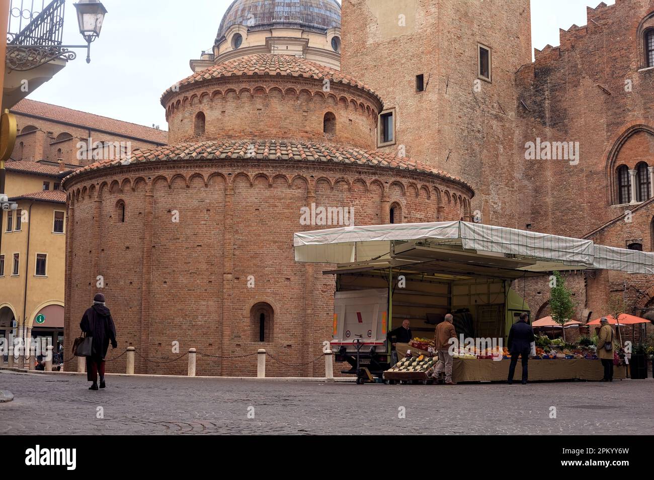 Grocery stall in a square behind historical buildings in a town on a ...