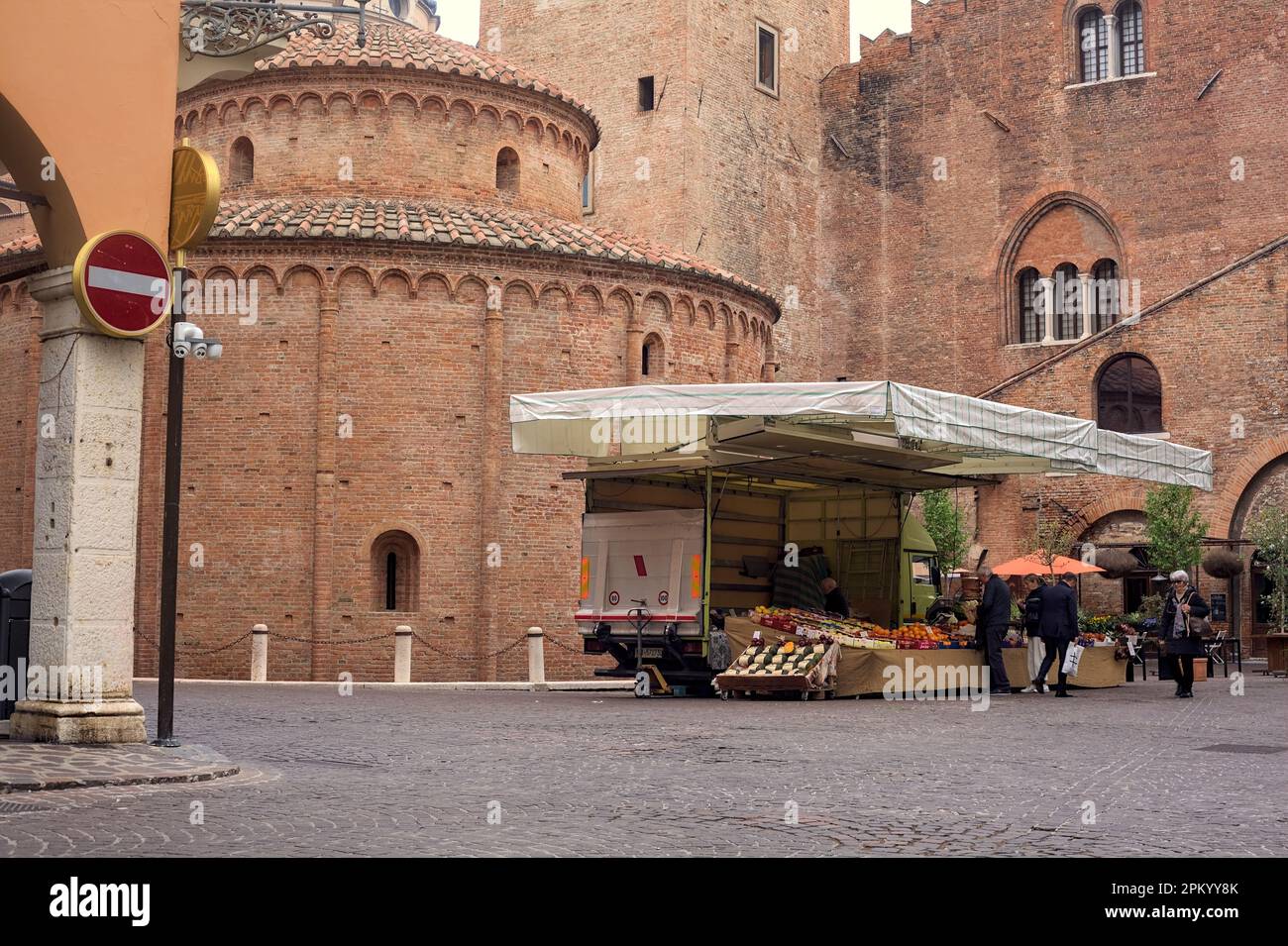 Grocery stall in a square behind historical buildings in a town on a ...