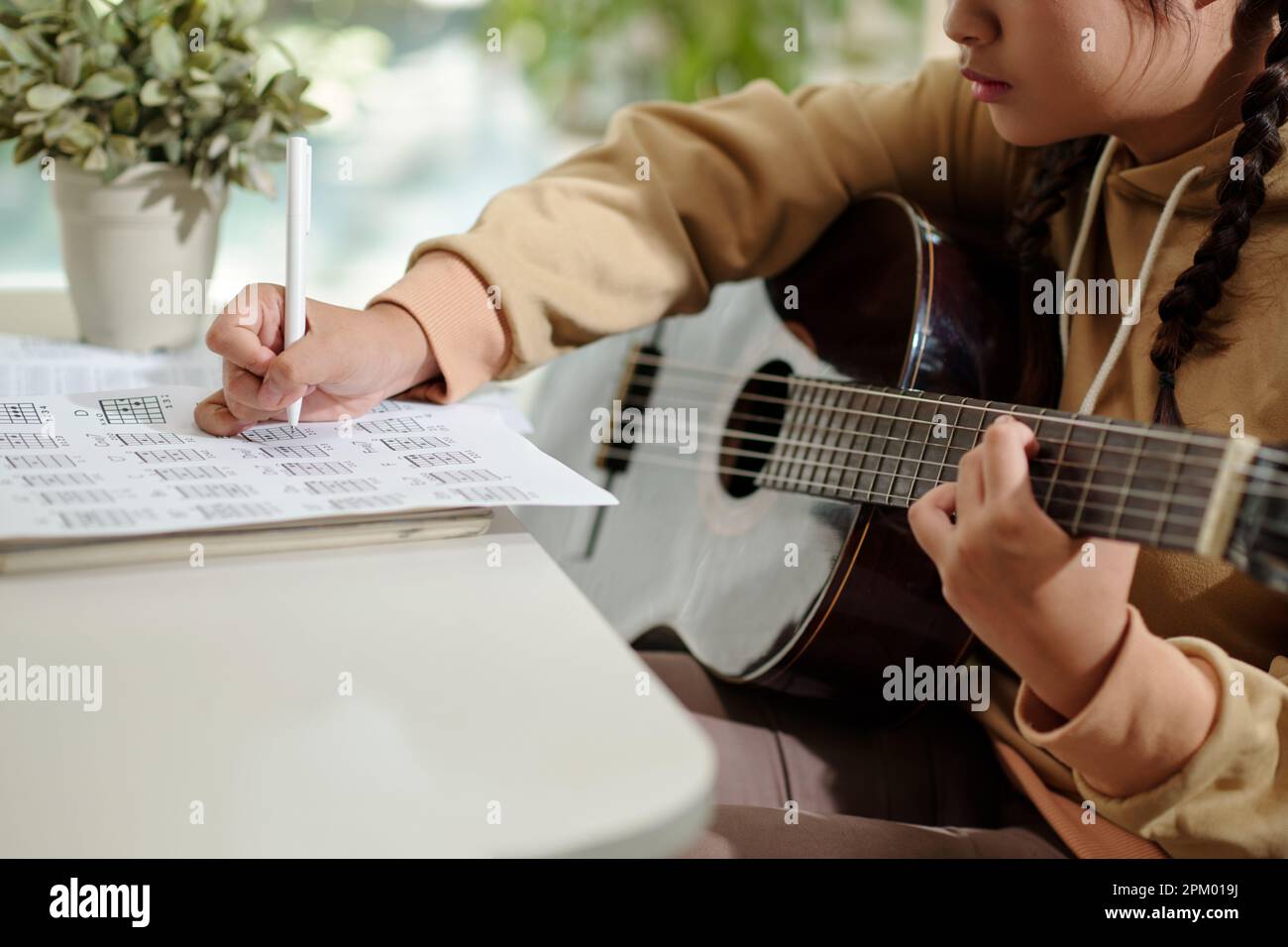 Musician playing guitar writing notes hi-res stock photography and ...