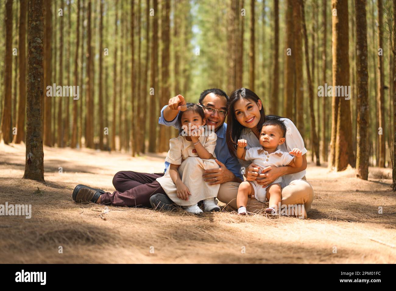 Happy parents and children looking at camera with smile at park Stock ...