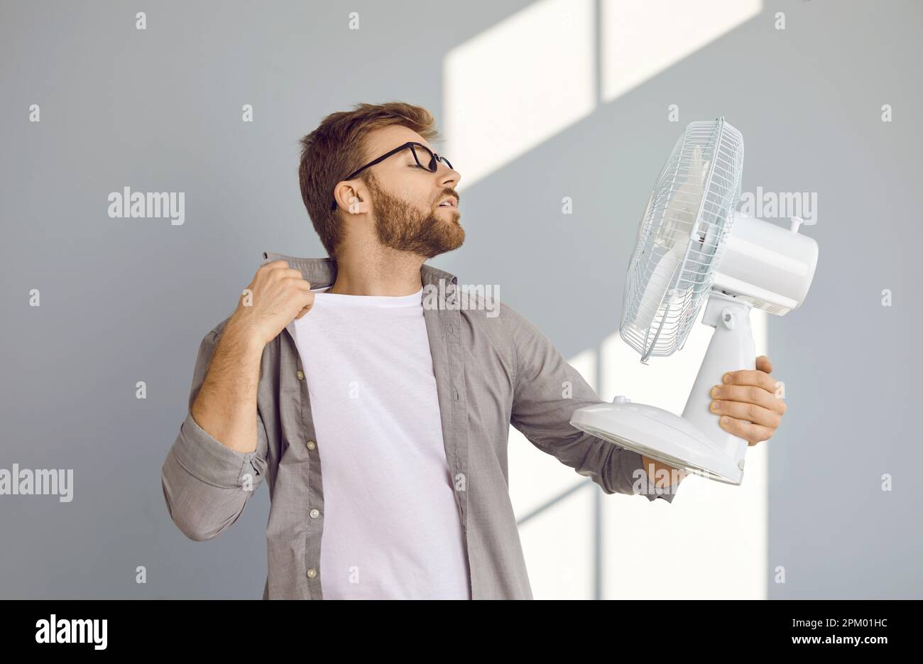 Man holding fan to cool the face hi-res stock photography and images ...