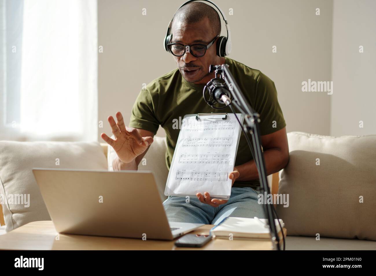 Teacher explaining how to read music notes at online class Stock Photo ...