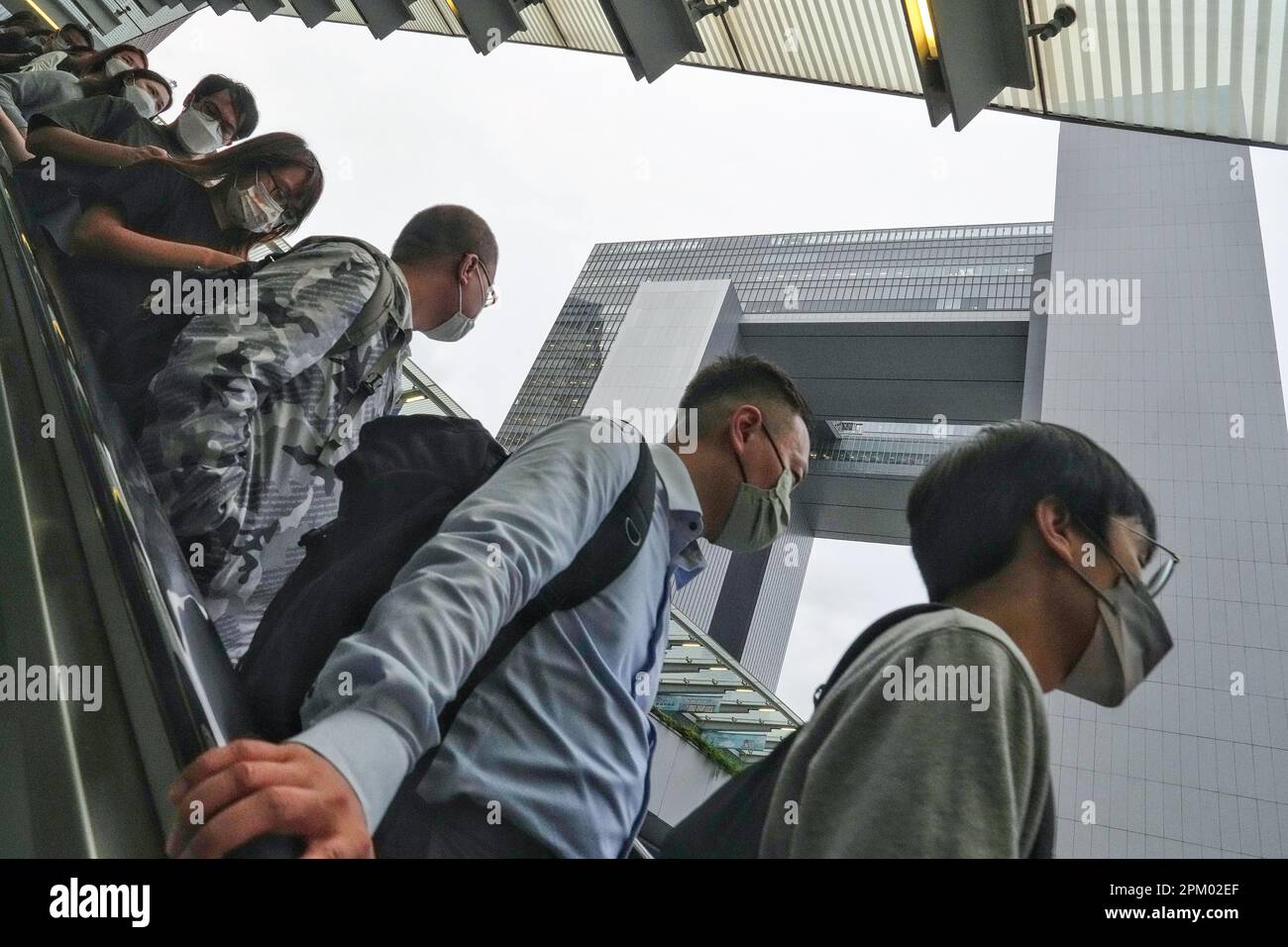 People walk through the bridge connecting the Central Government ...
