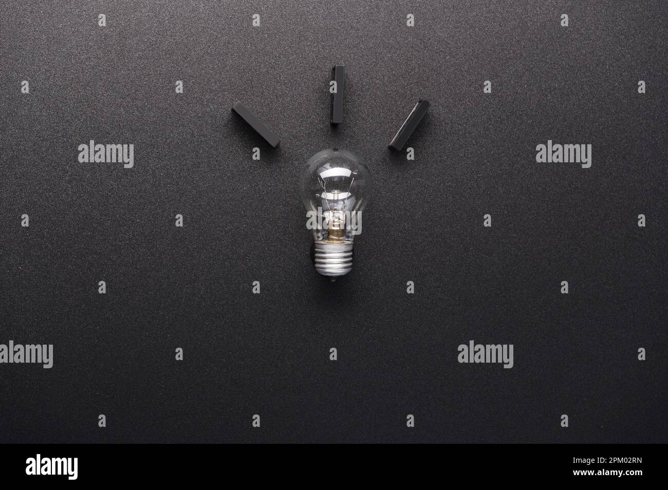 Light bulb on a black background. Light bulb idea symbol. Sign of ...