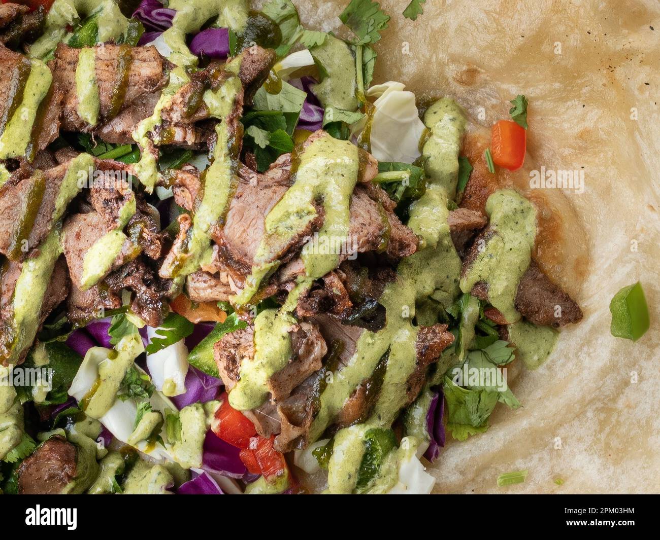 A Mexican-style burrito, with a soft wheat tortilla and ground beef ...