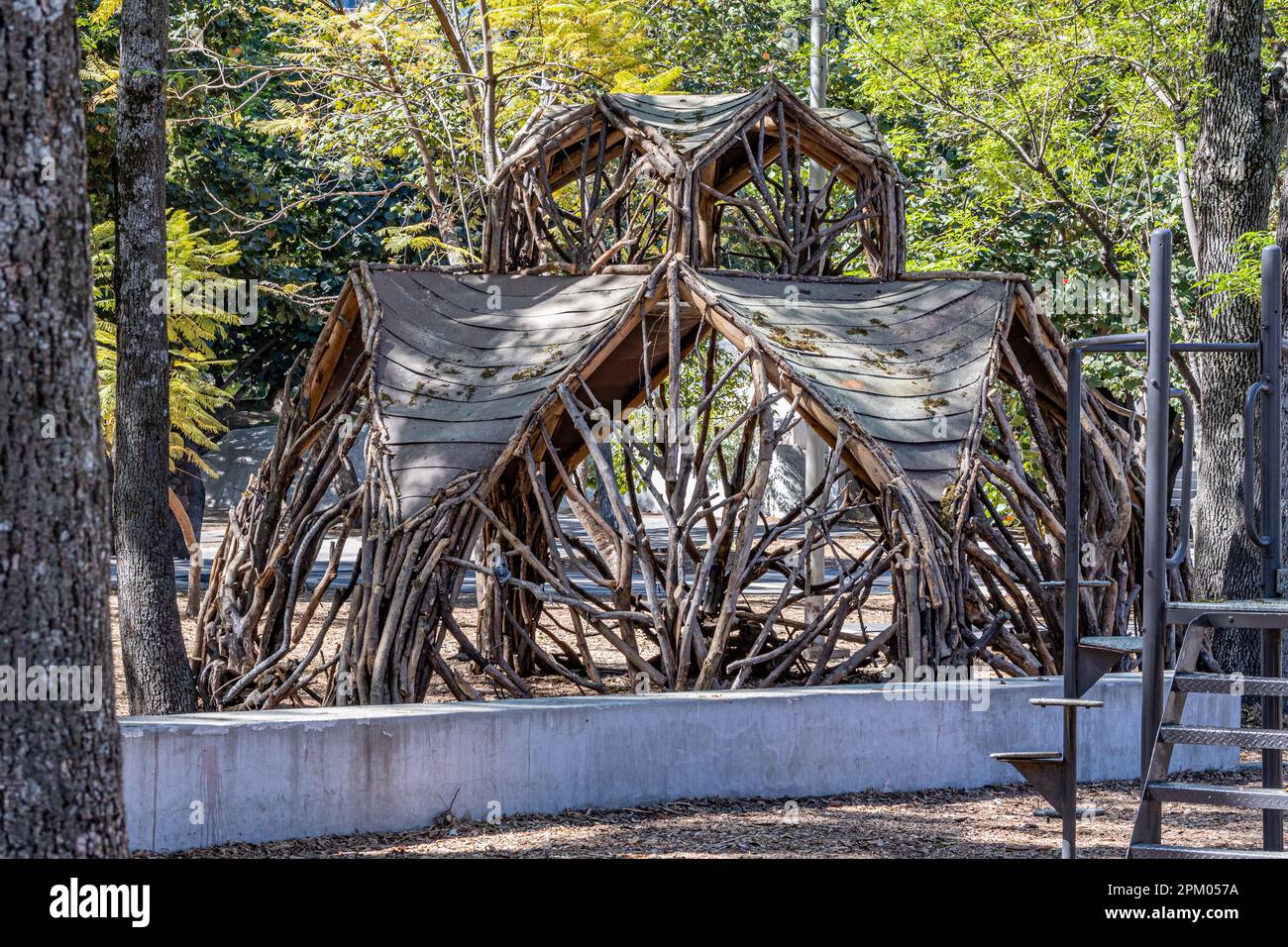 Ecological rustic open cabin built with branches and wooden trunks ...