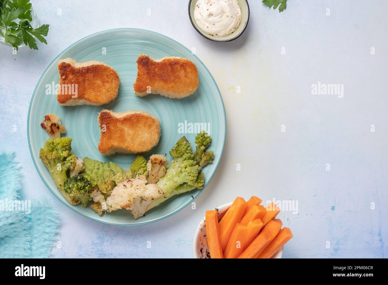 Kids food. Fish shaped nuggets with vegetable Stock Photo - Alamy