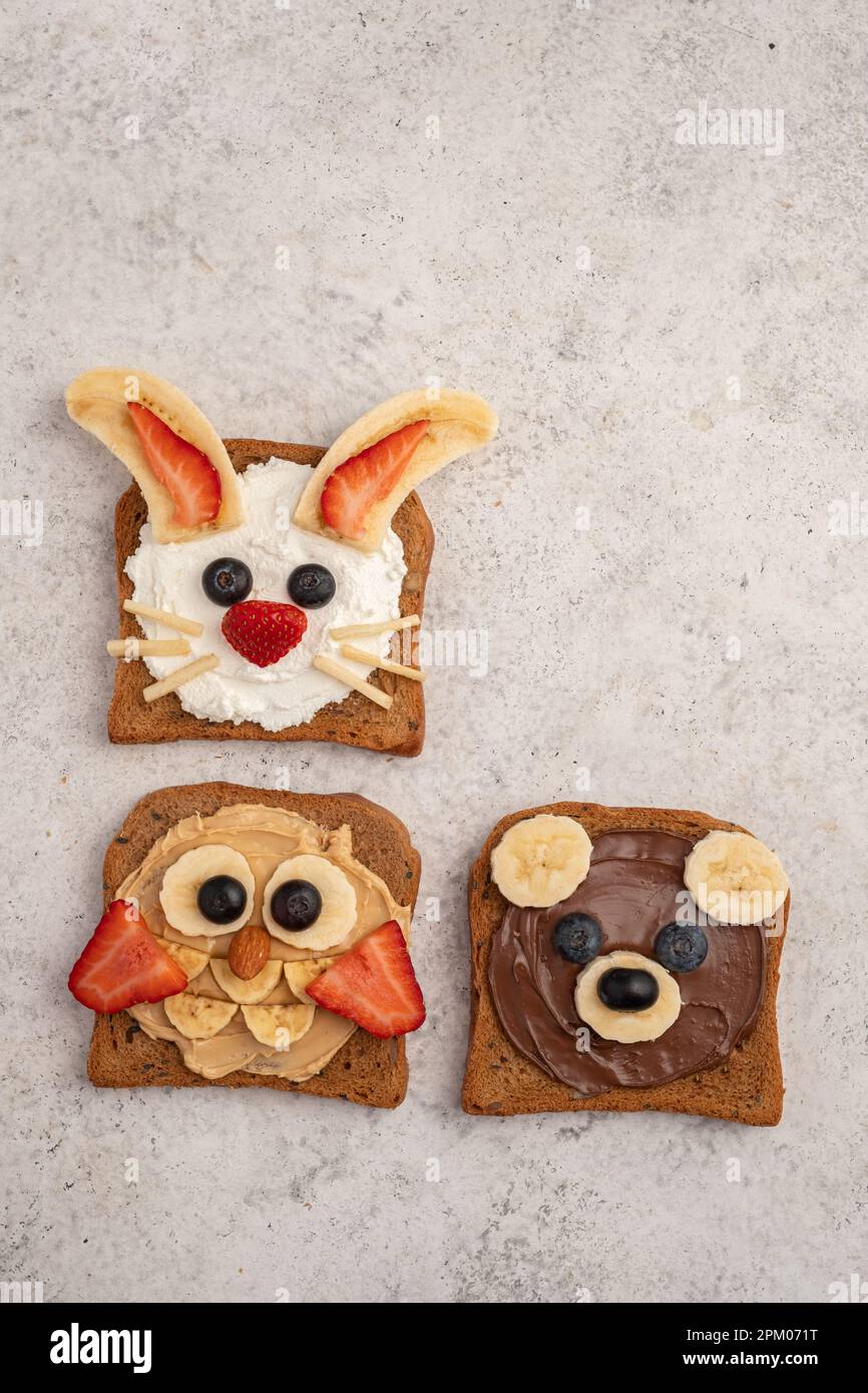 Funny animal faces toasts for kids lunch Stock Photo - Alamy