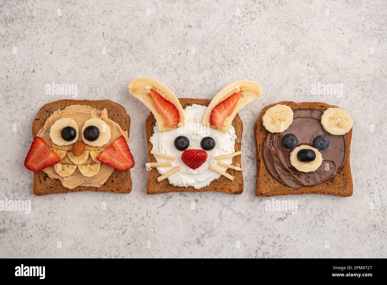 Funny animal faces toasts for kids lunch Stock Photo - Alamy