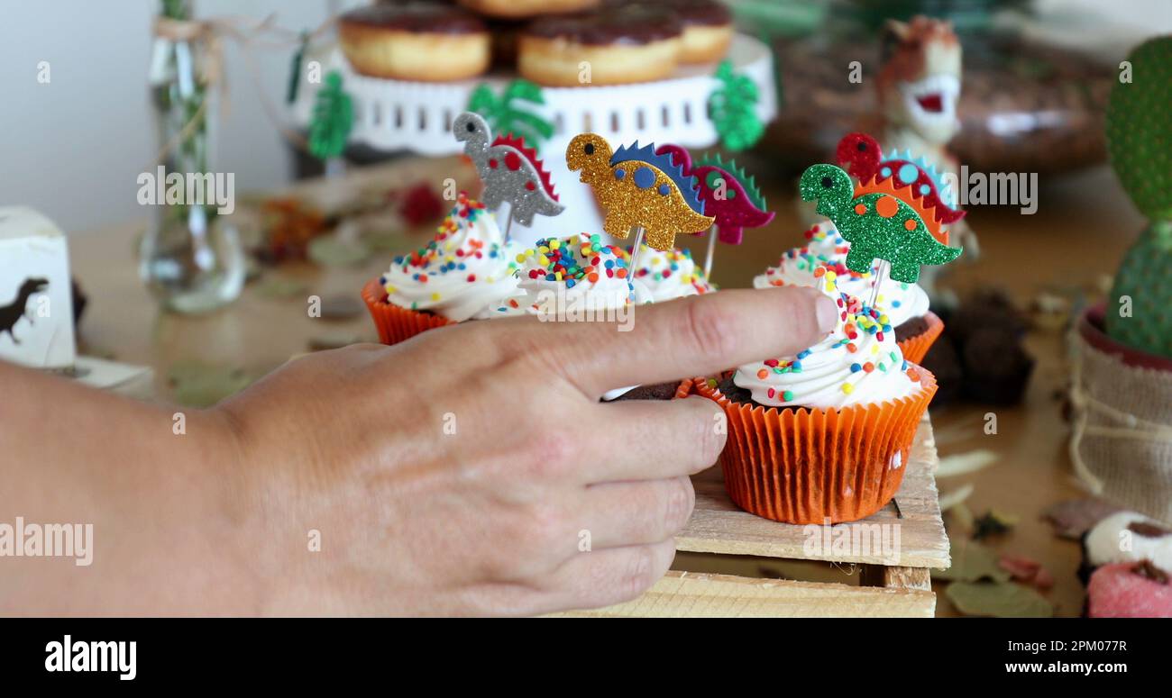 Cupcakes on display at birthday celebration table Stock Photo - Alamy