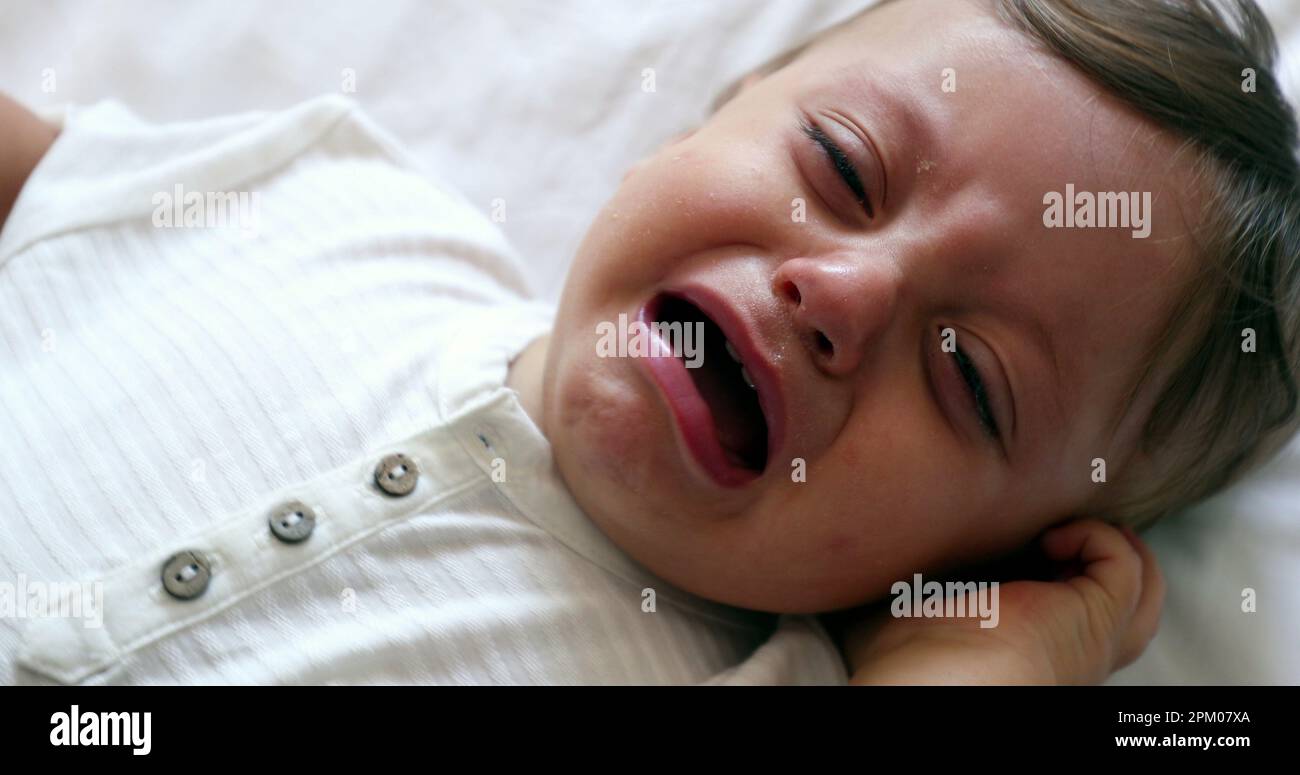Tearful baby toddler crying. One year told child cries Stock Photo - Alamy