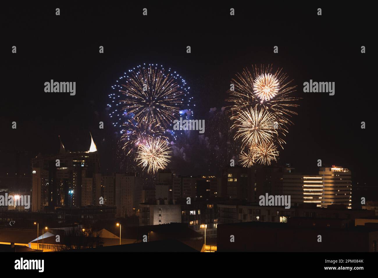A nighttime view of a busy cityscape with a spectacular display of ...
