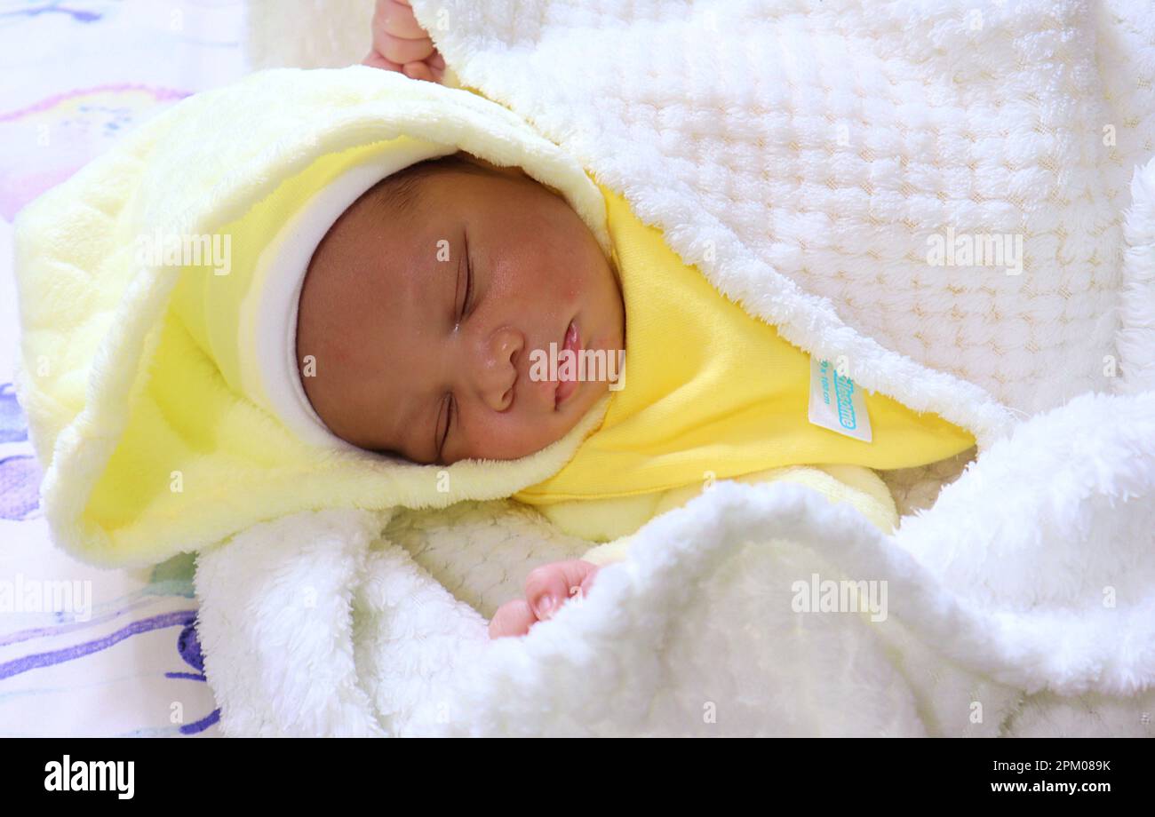 Newborn baby in deep sleep covered in blankets Stock Photo - Alamy