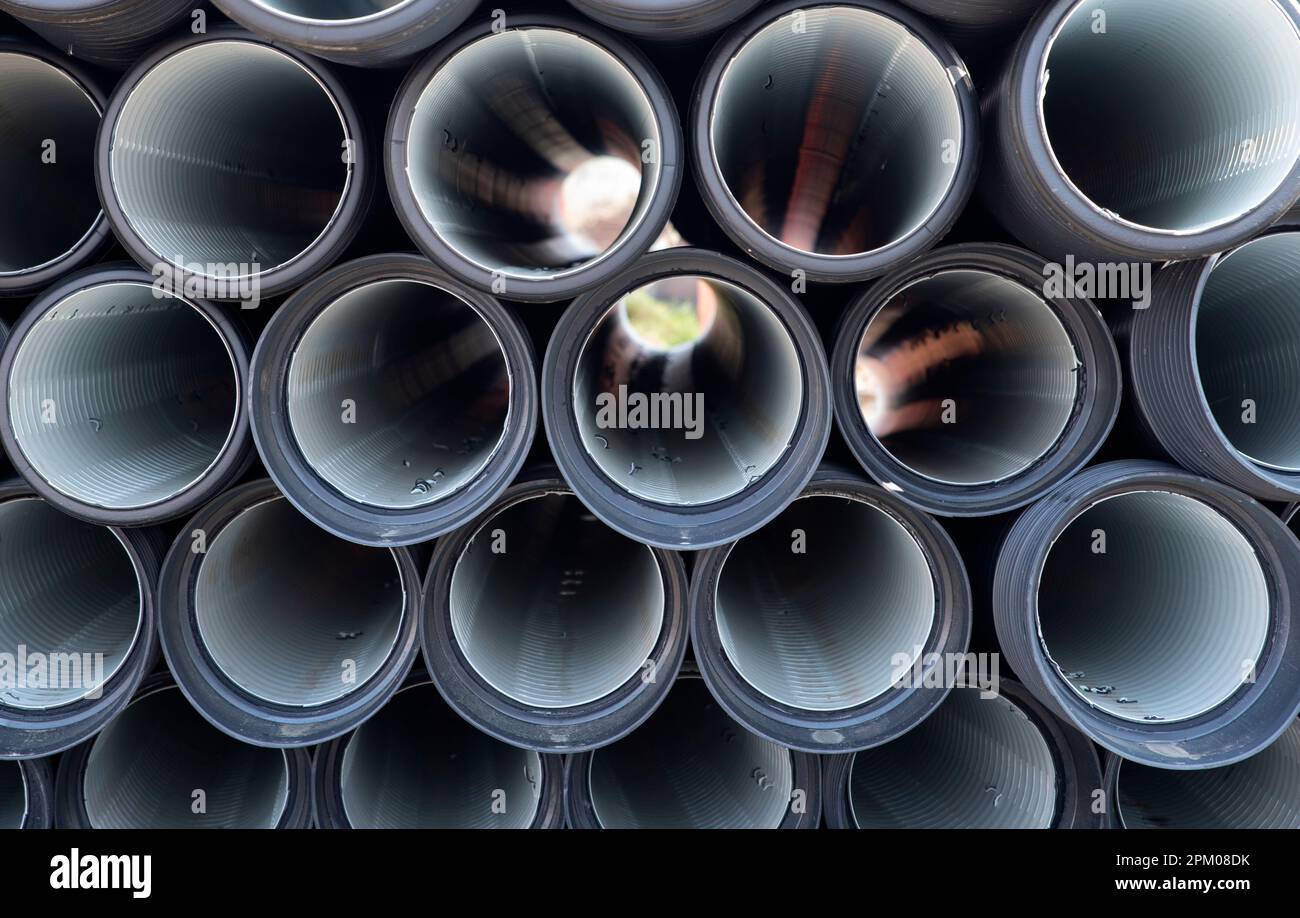 construction pipes stacked on the street Stock Photo - Alamy