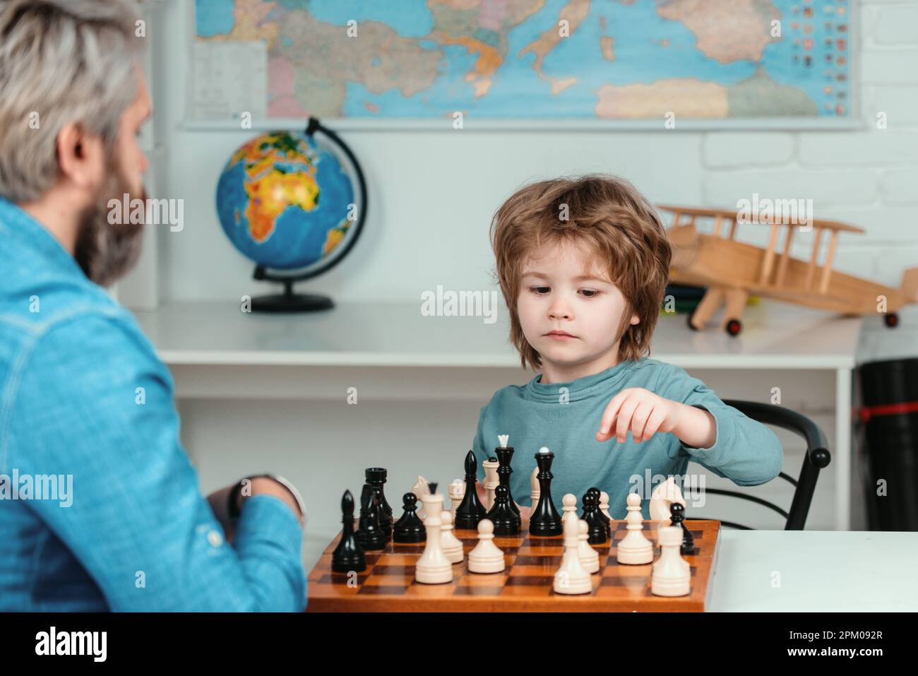 Child chess school. Preschooler or schoolboy, Boy kid playing chess at ...
