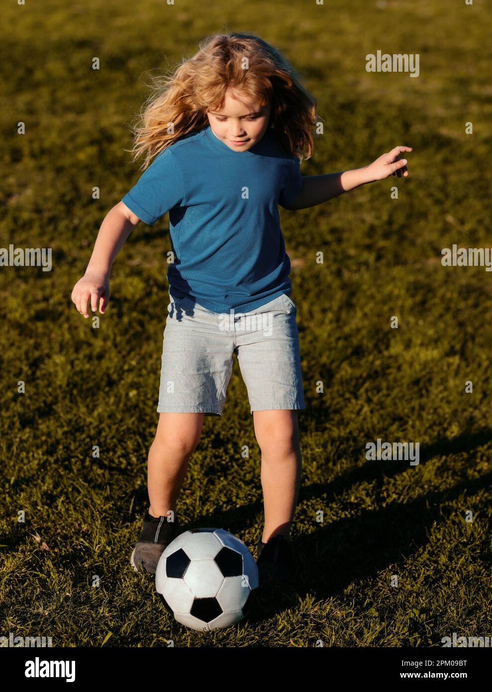 Soccer kid boy playing football. Child boy play football on outdoor ...