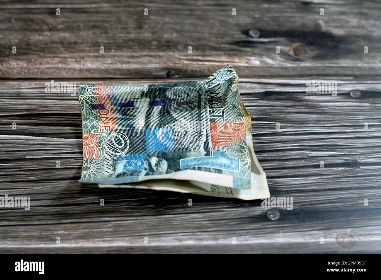 Selective focus of crumpled Kuwaiti money of 1 KWD one Kuwait dinar ...