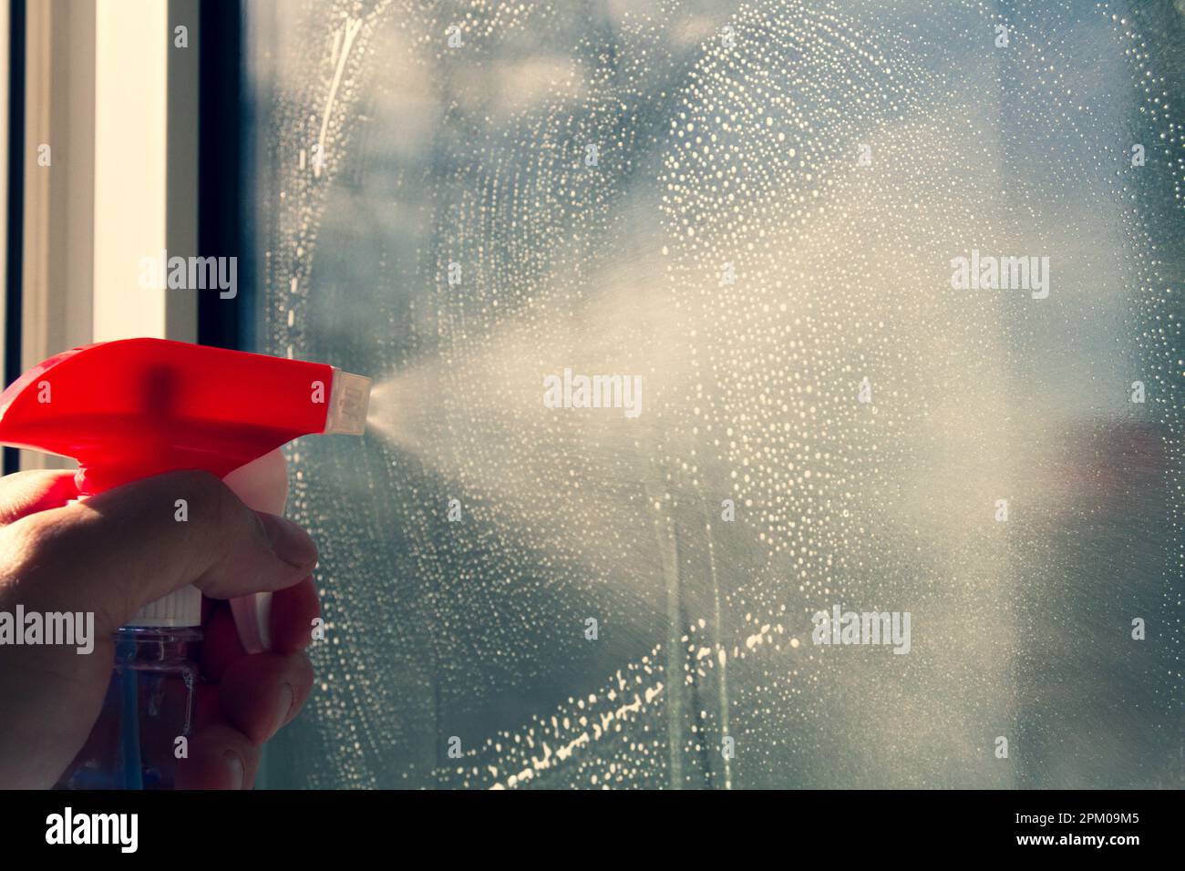 Window washing. Cleaning the window with a brush and foam. The concept ...