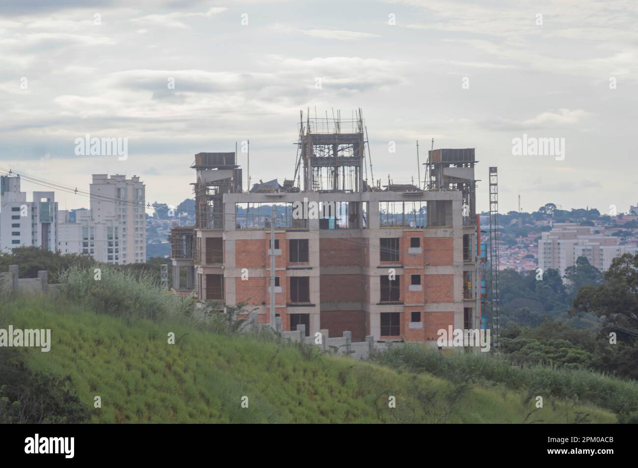 Construction in progress with grass around the landscape of a city in ...