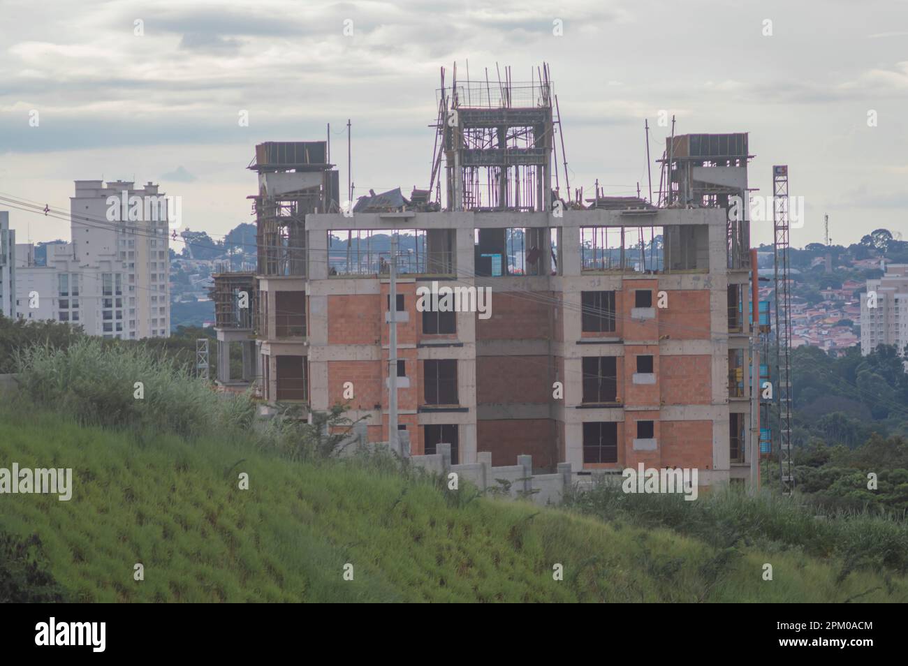 Construction in progress with grass around the landscape of a city in ...