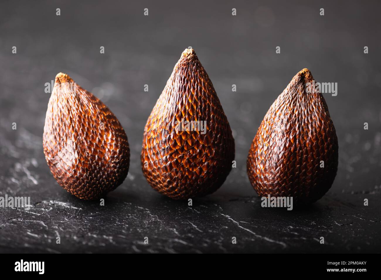 Salak fruit or snake fruit on black background. Exotic fruits studio ...