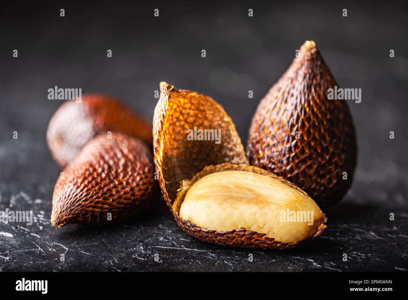 Salak fruit or snake fruit on black background. Exotic fruits studio ...