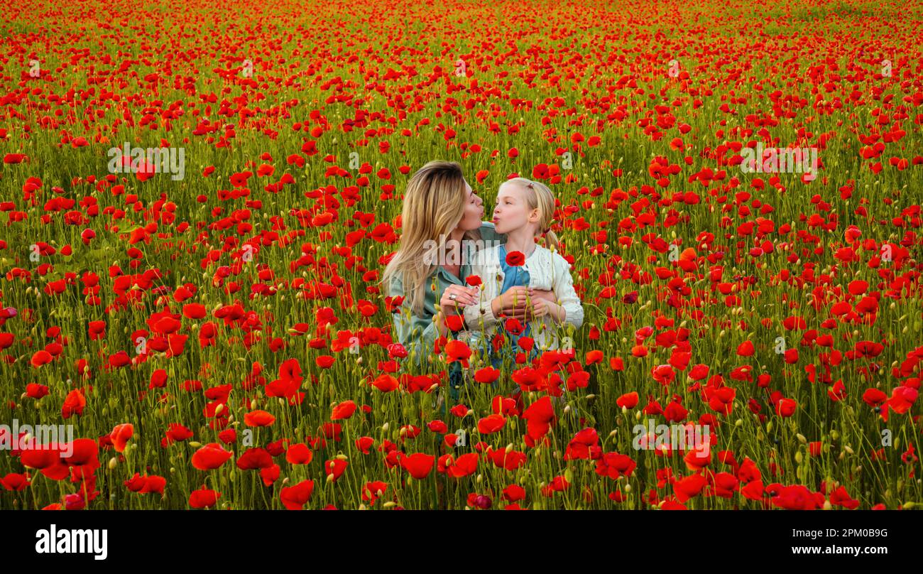 Happy family resting on a beautiful poppy field. Family having fun ...
