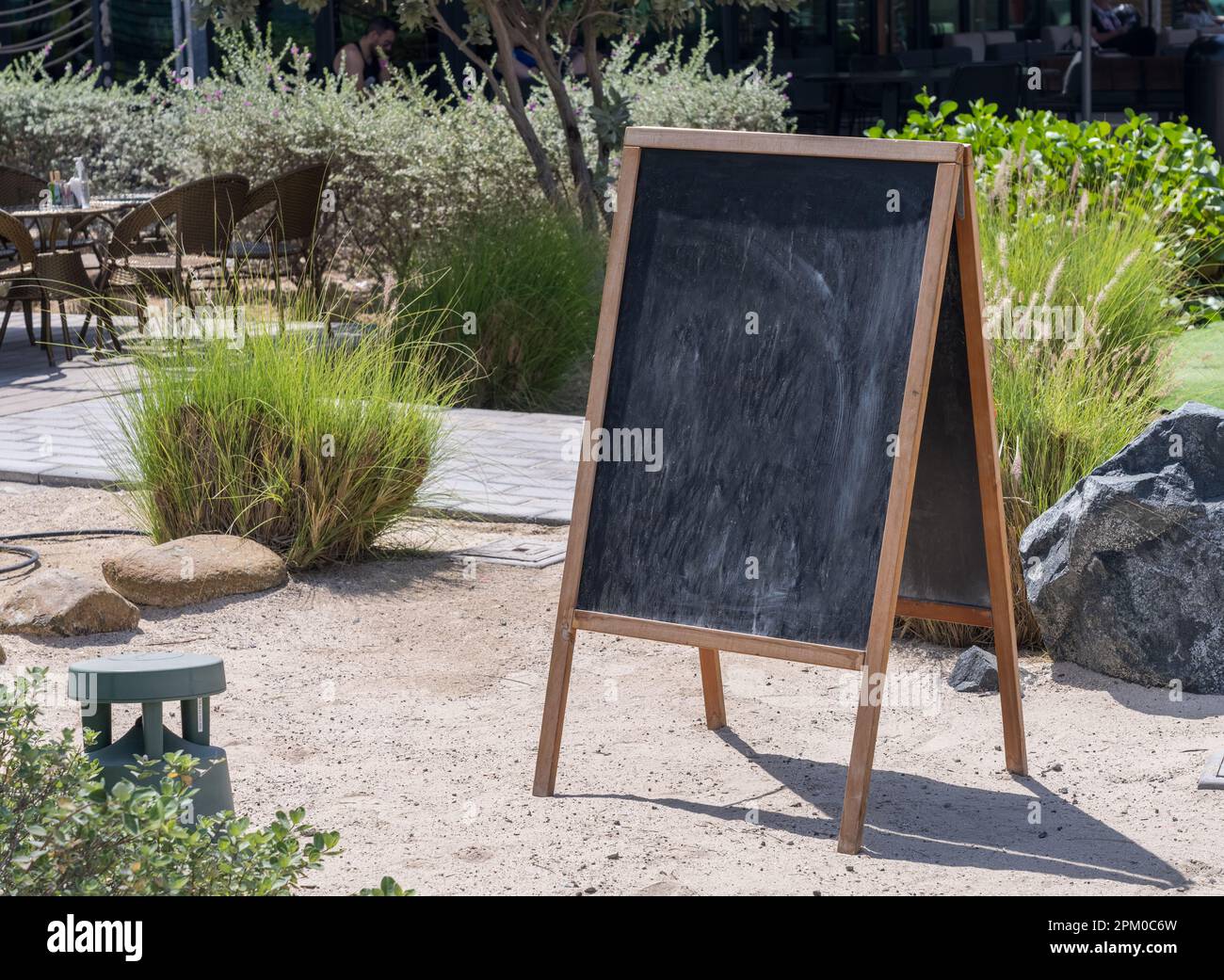Wooden blackboard with blank empty surface ready for message outside ...