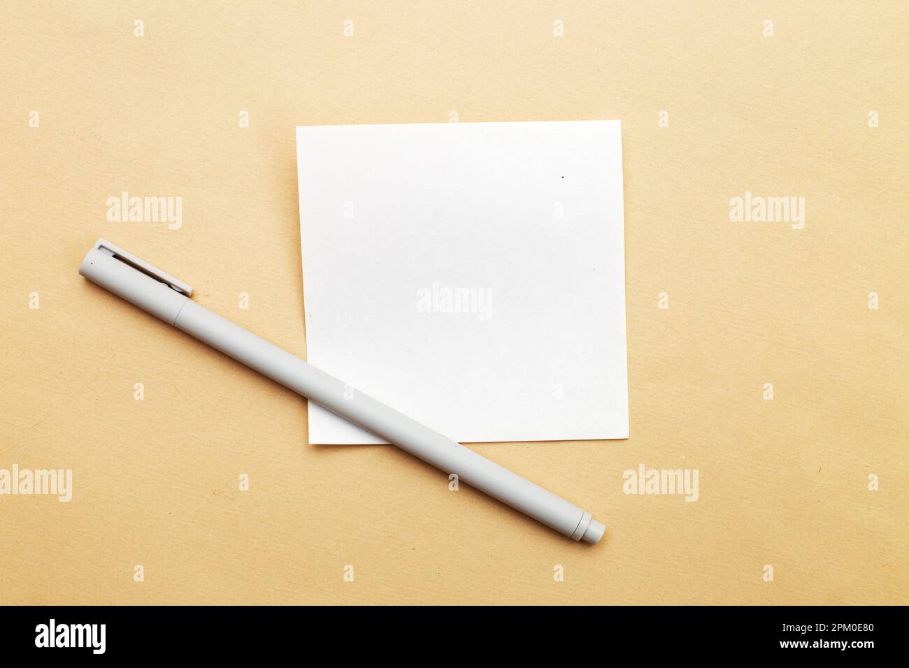Top view of blank note paper with pen on beige background. Copy space ...