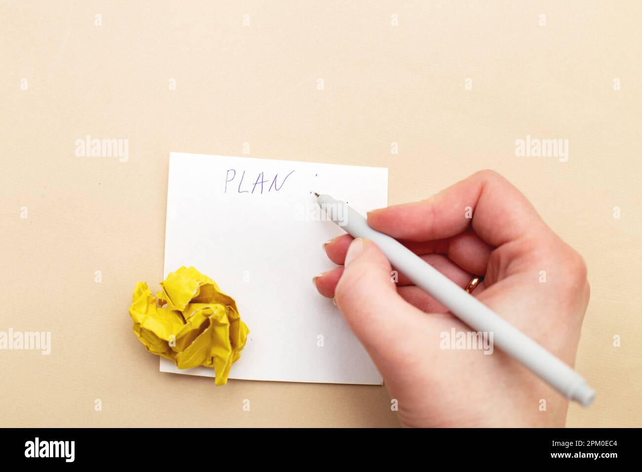 Female woman hand writing a plan or to do list on piece of paper for ...