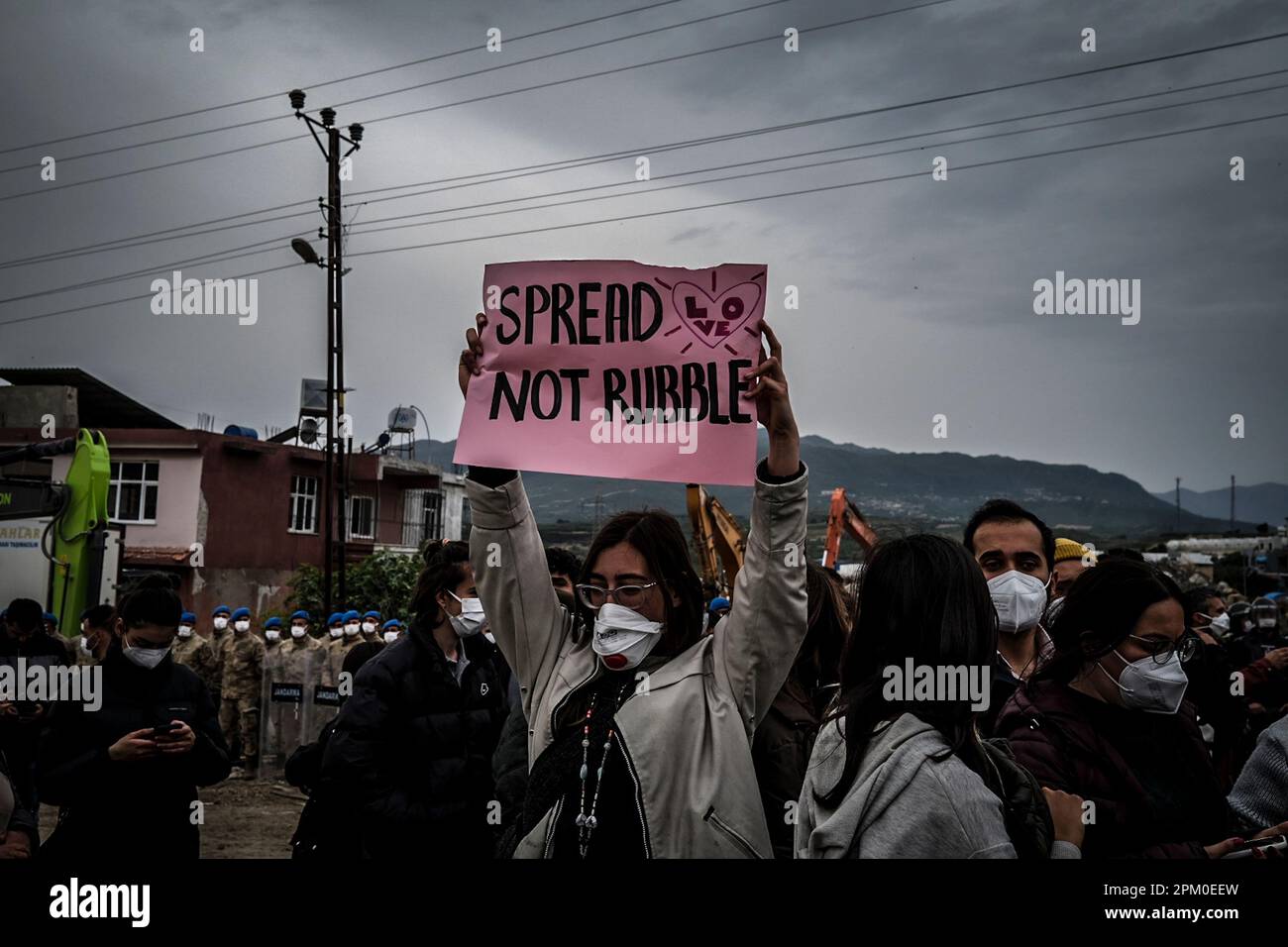 A protester holds a placard reading "Spread love not rubble" during the ...