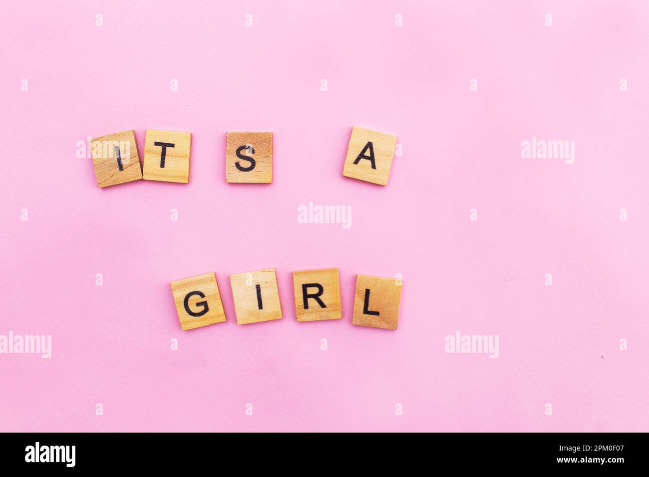 Word Its a girl by wooden cubes on a pink background. Symbol of ...