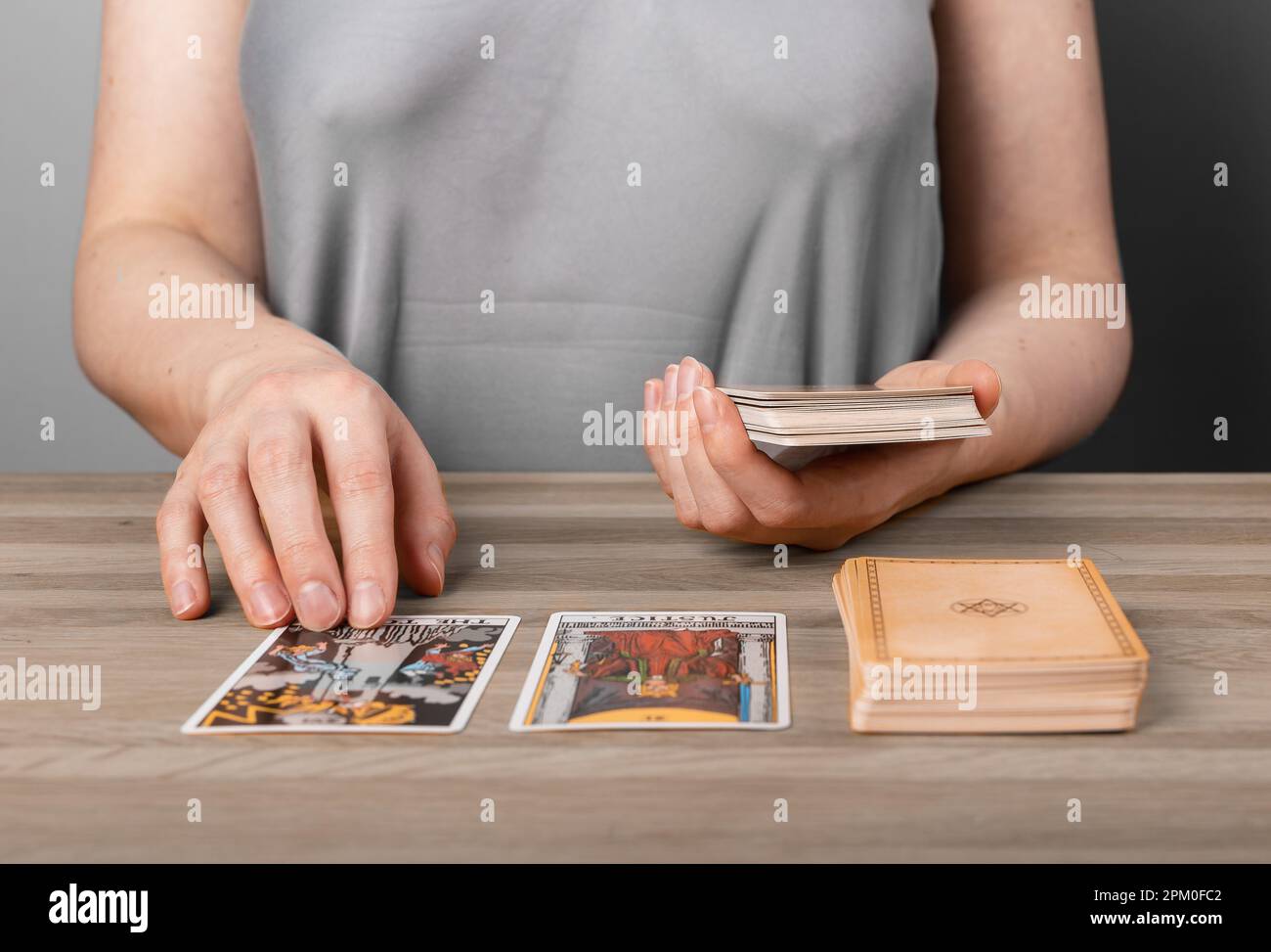 Lodz, Poland April 07 2023 Fortune teller spreading tarot cards on wood ...