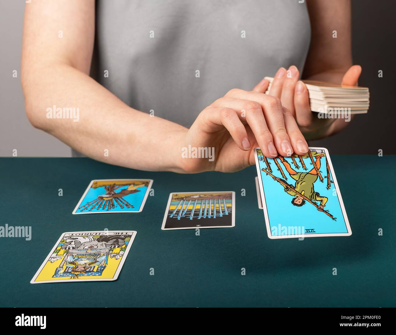 Lodz, Poland April 07 2023 Tarot reader spreading taro cards on desk ...