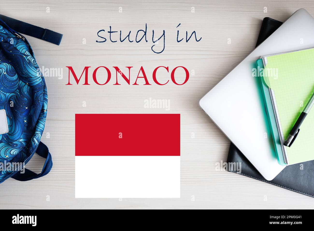 Study in Monaco. Background with notepad, laptop and backpack ...