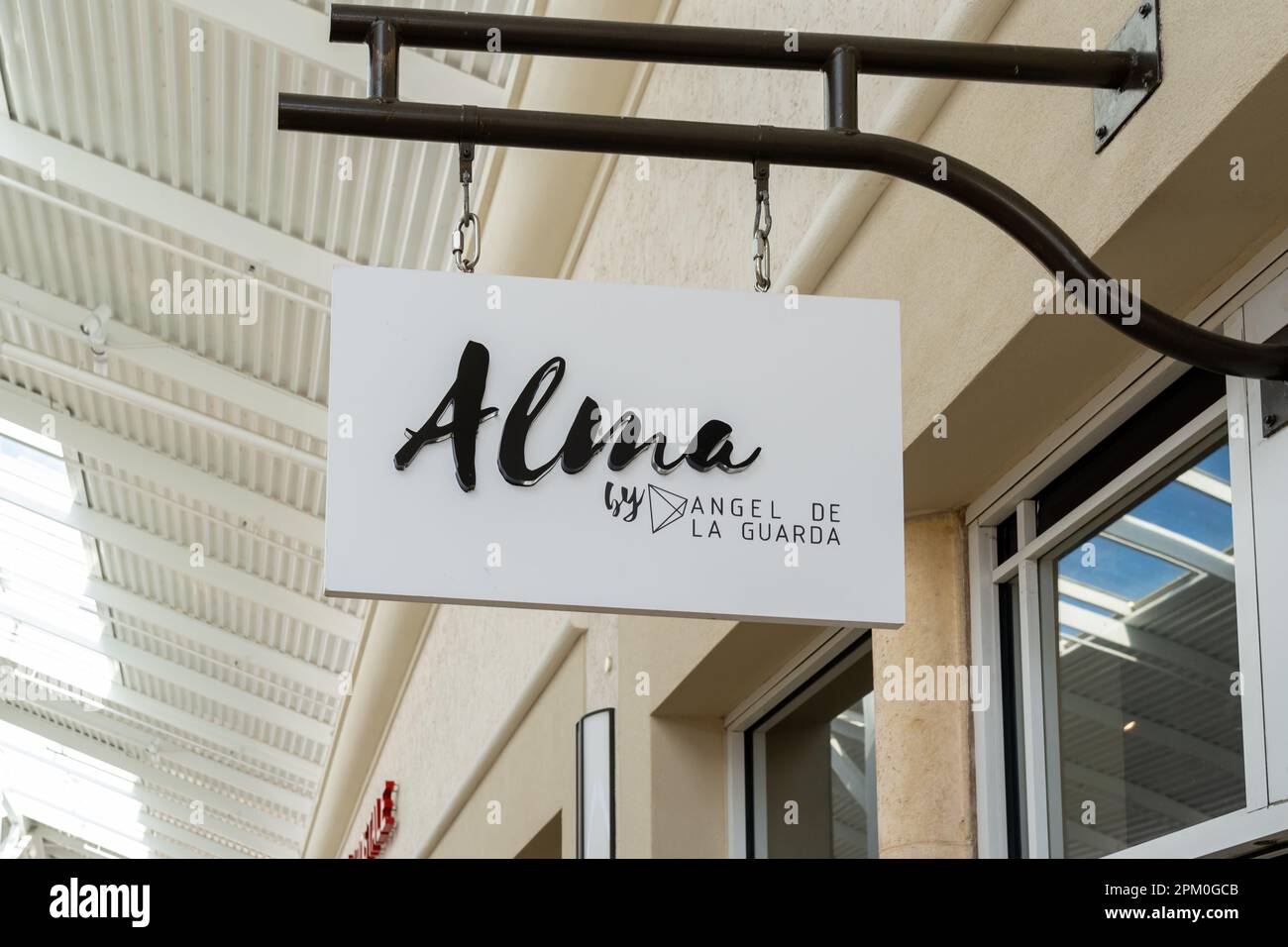 Close up of Alma By Ángel de la Guarda store hanging sign is shown ...