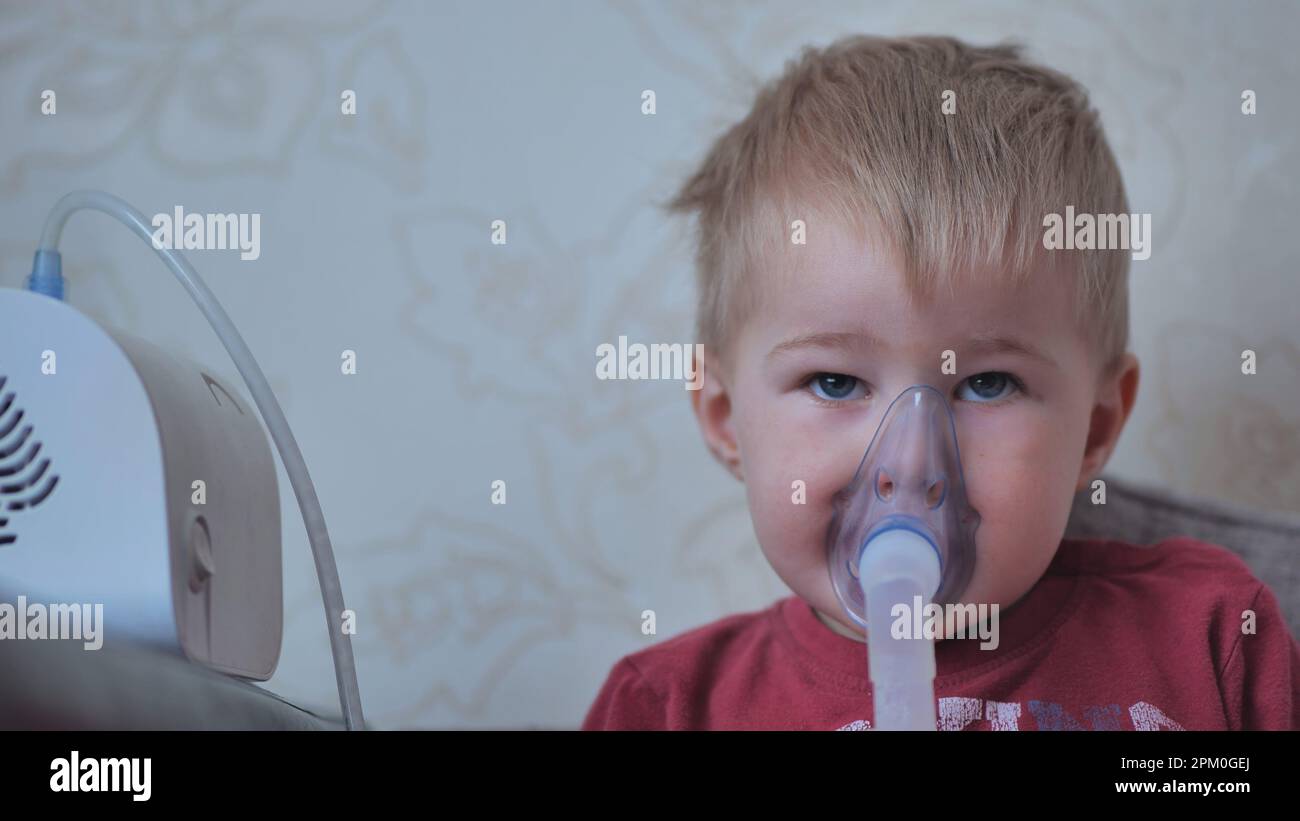 Funny boy breathing through an inhaler mask Stock Photo - Alamy