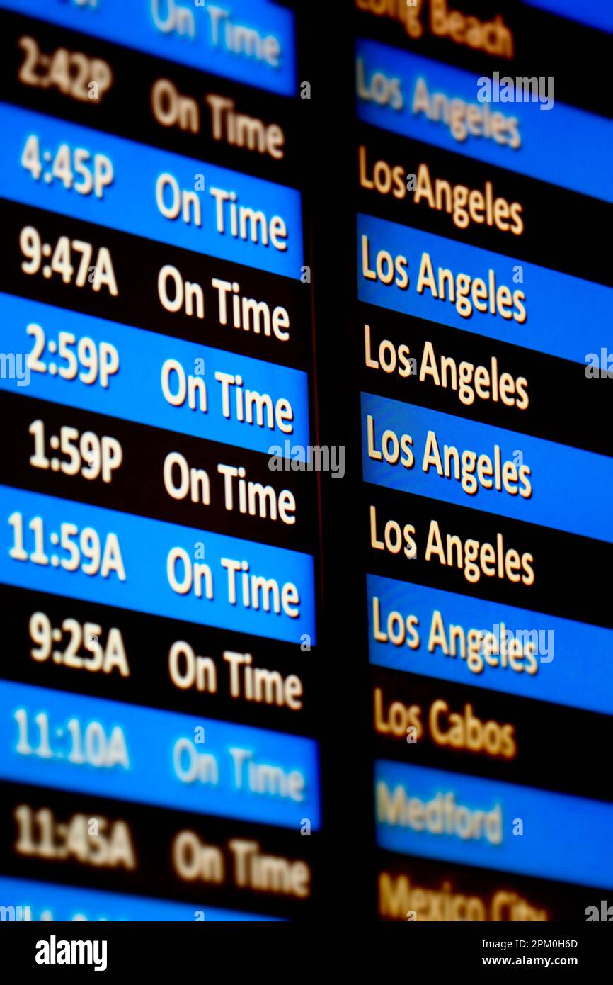 Airline flights information board in airport with arrivals and ...
