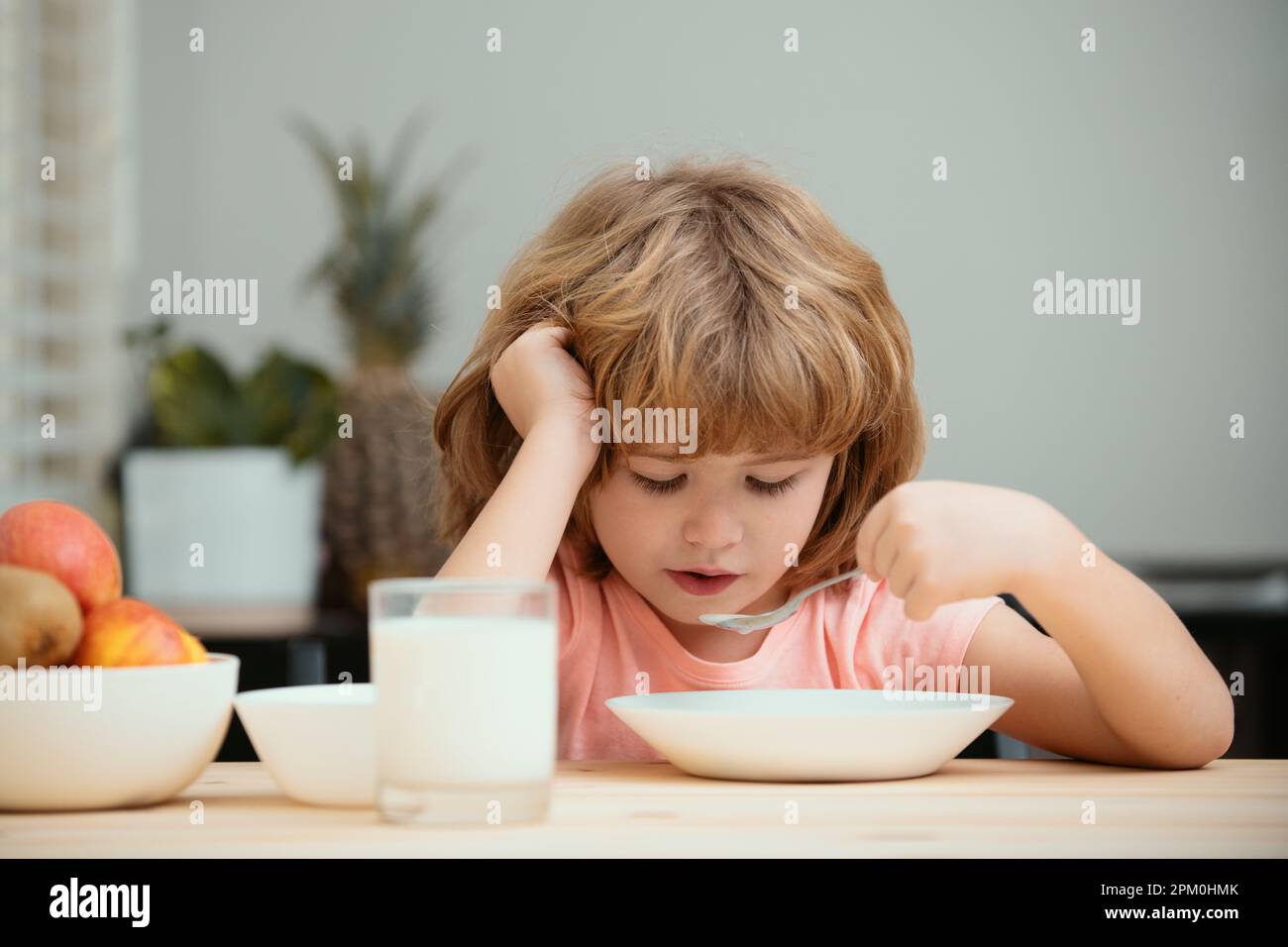 Funny kid with plate of soup. Child dinner Stock Photo - Alamy