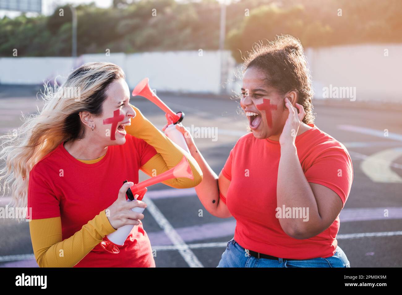 Two young fans screaming with joy to celebrate the success of their ...